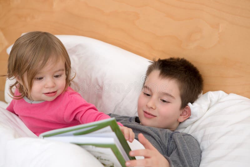 Siblings Reading Together stock photo. Image of happy - 29495174