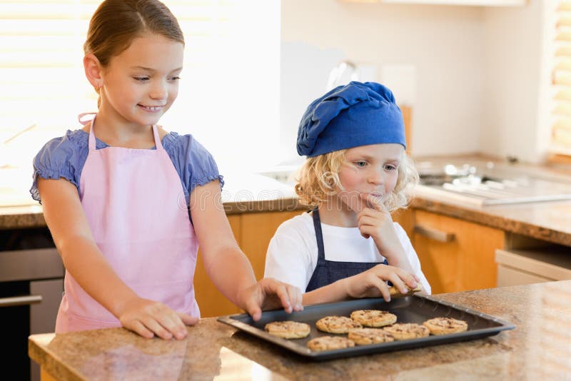 Girl stealing a cookie stock image. Image of homemade - 22345153