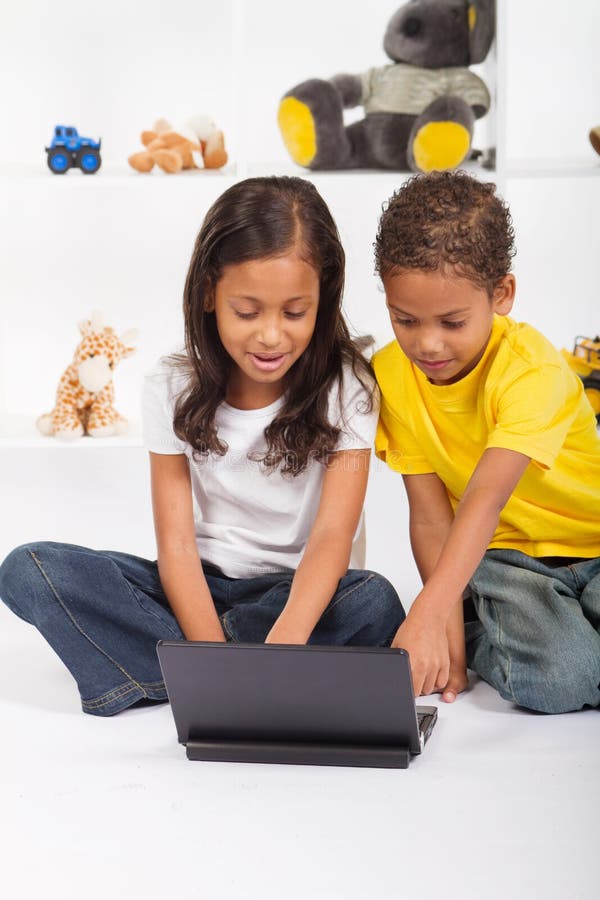 Brothers Working on Laptop Computer Sitting on Floor Stock Photo ...
