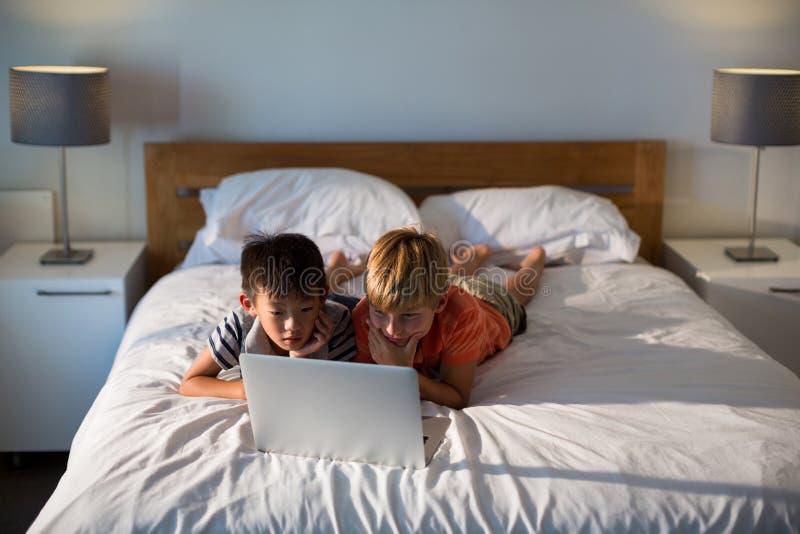 Siblings Using Laptop on Bed Stock Image - Image of brother, domestic ...