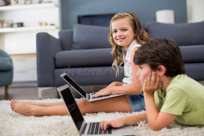 Siblings Using Laptop in Living Room Stock Image - Image of domicile ...