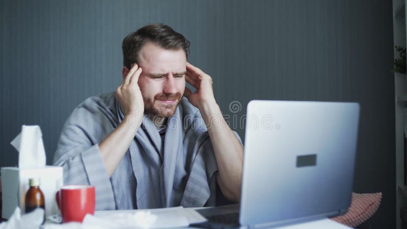 Sick Business Man Working with Laptop Computer and Documents at Home ...