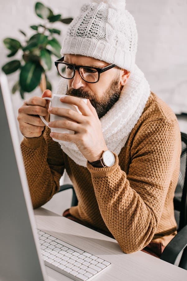 Sick Businessman in Scarf and Knitted Hat Working at Computer Desk and ...