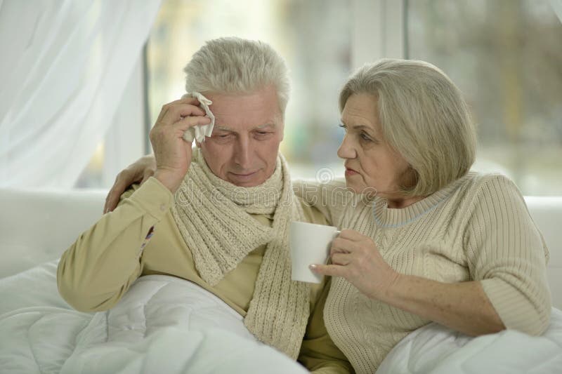 Sick elderly couple in bed stock image. Image of portrait - 70745769