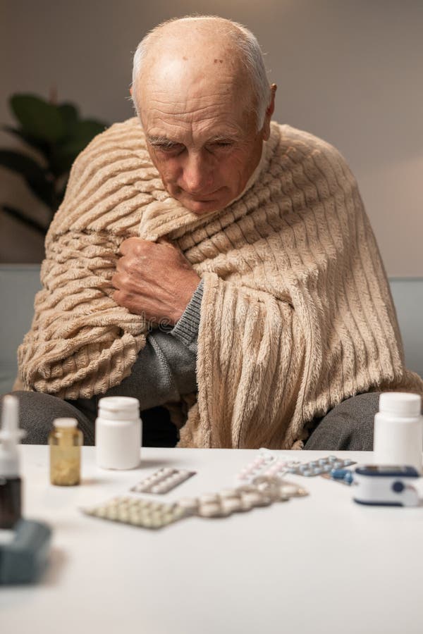 Sick Elderly Man Feeling Cold, Covered with Blanket, Sitting on Sofa ...