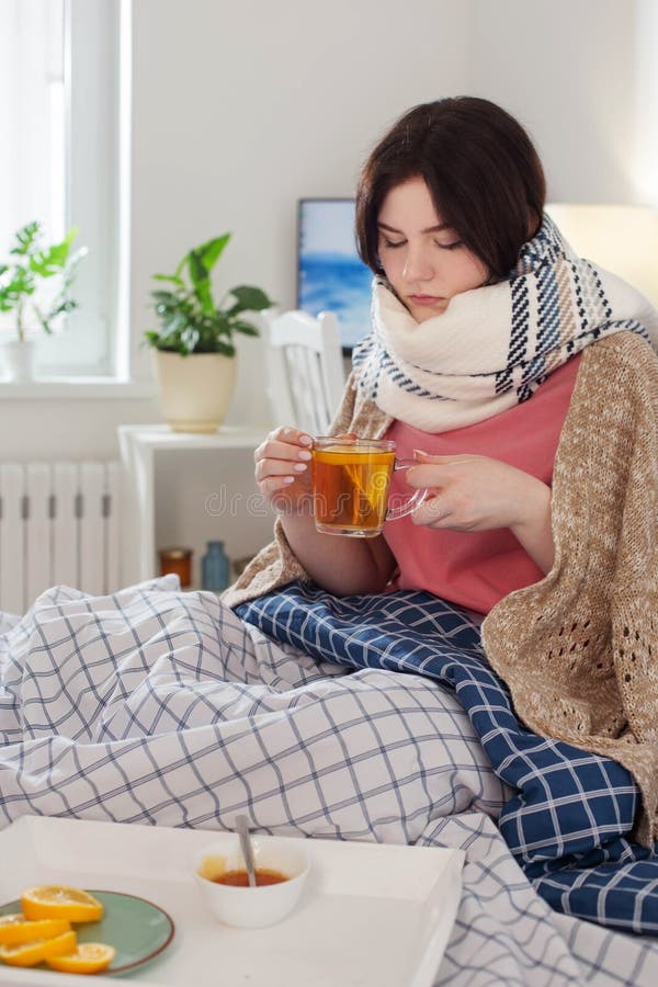 Sick girl with tea in bed stock photo. Image of cold - 239310608