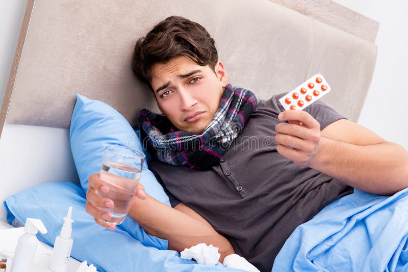 The Sick Ill Man in the Bed Taking Medicines and Drugs Stock Photo ...