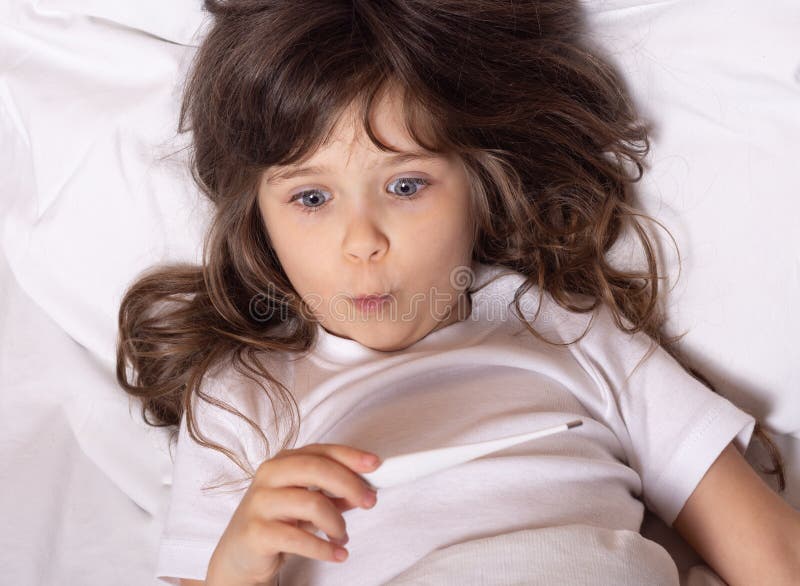 Sick Kid with Thermometer Laying in Bed and Taking Temperature ...