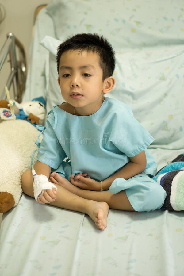 A Sick Little Boy in Hospital Bed. Stock Photo - Image of looking ...