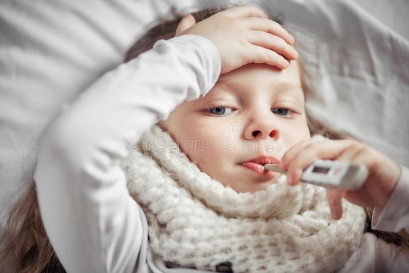 A Sick Little Girl Lying in Bed with a Thermometer Stock Photo - Image ...