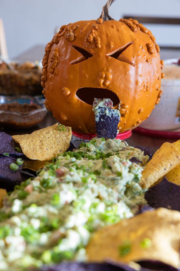 A Sick Looking Pumpkin Throwing Up Green Stuff on a Plate of Chips ...