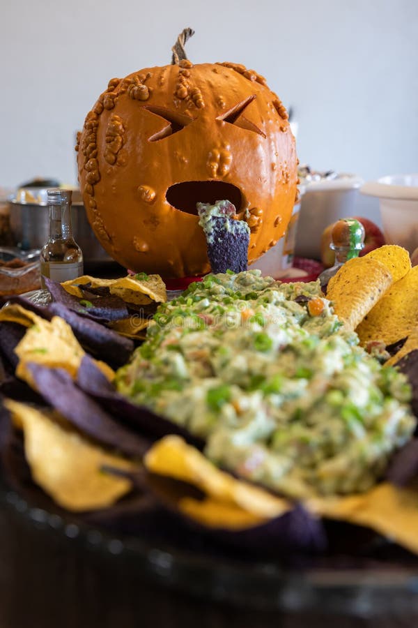 A Sick Looking Pumpkin Throwing Up Green Stuff on a Plate of Chips ...