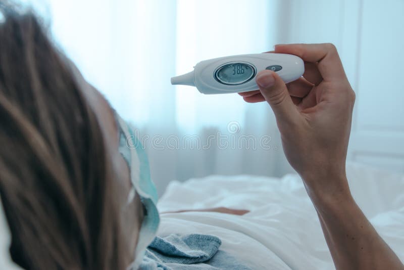 Sick Man in Bed Looks at a Thermometer Which Indicates a High Body ...