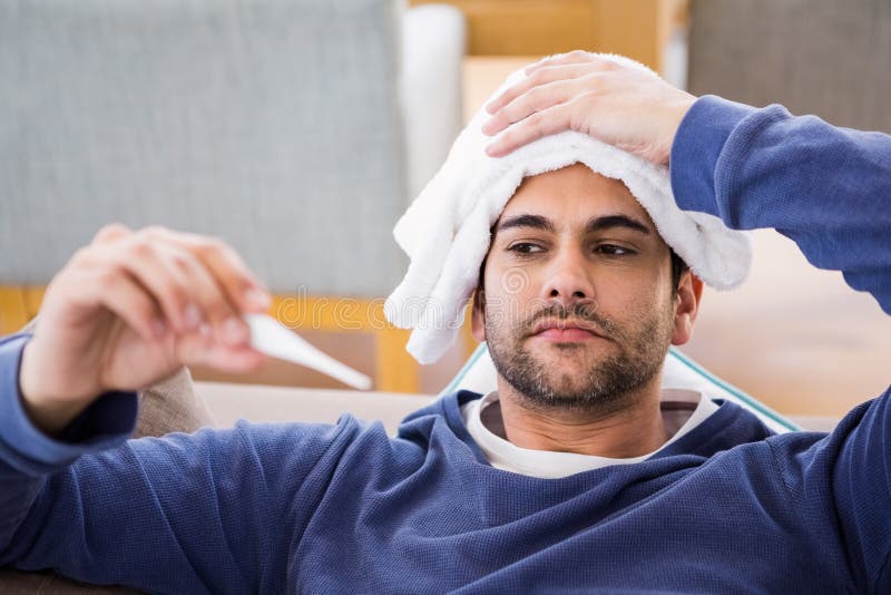 Sick Man Checking His Temperature Stock Photo - Image of disease, male ...