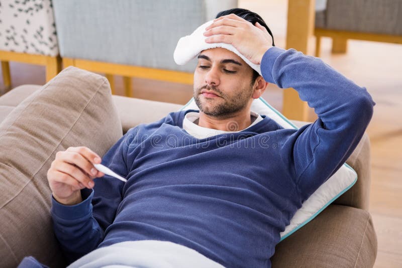 Sick Man Checking His Temperature Stock Image - Image of illness, lying ...
