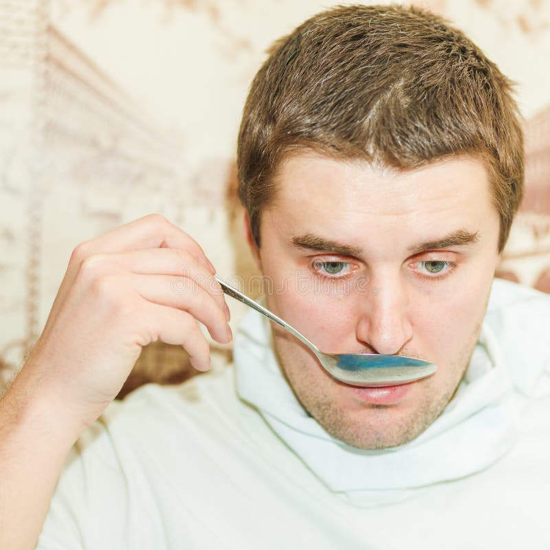 A Sick Man Drinks a Medicine from a Spoon Stock Photo - Image of little ...