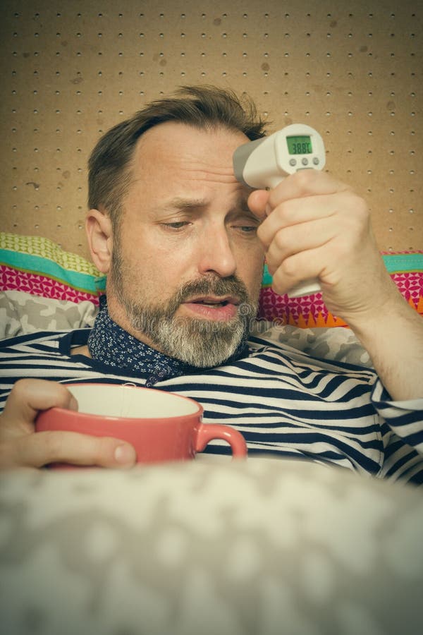 Sick Man with Flu and Cold Checking His Teplerature with Thermometer ...