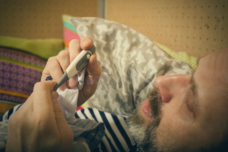 Sick Man with Flu and Cold Checking His Teplerature with Thermometer ...