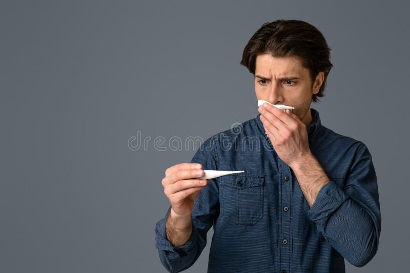 Sick Man Holding Thermometer, Checking His High Temperature Over Light ...