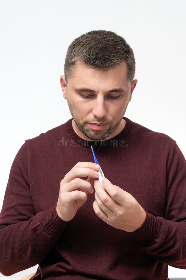A Sick Man Holds A Thermometer In His Hands Healthcare And Treatment
