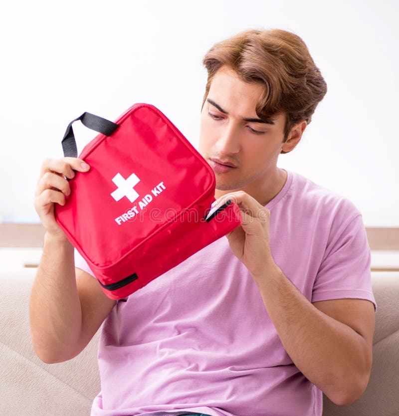 Sick Man at Home with First Aid Kit Stock Photo - Image of couch ...