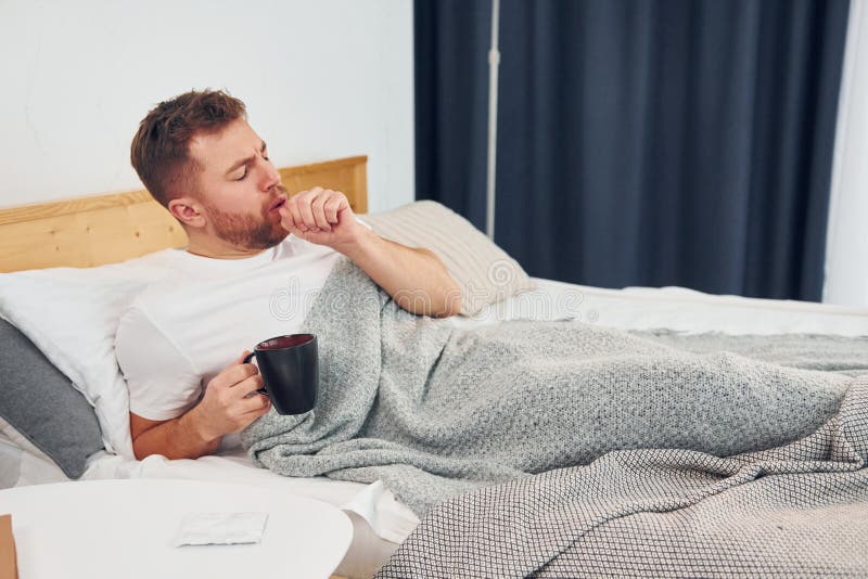 Sick Man Laying Down on the Bed at Home and Feels Bad. Conception of ...