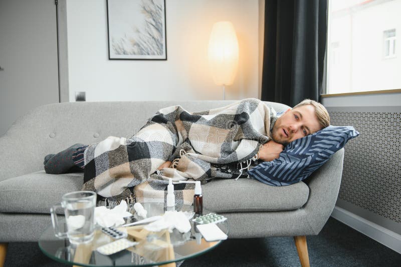 Sick Man on Sofa at Home in Living Room. Man Feeling Sick with Cold and ...