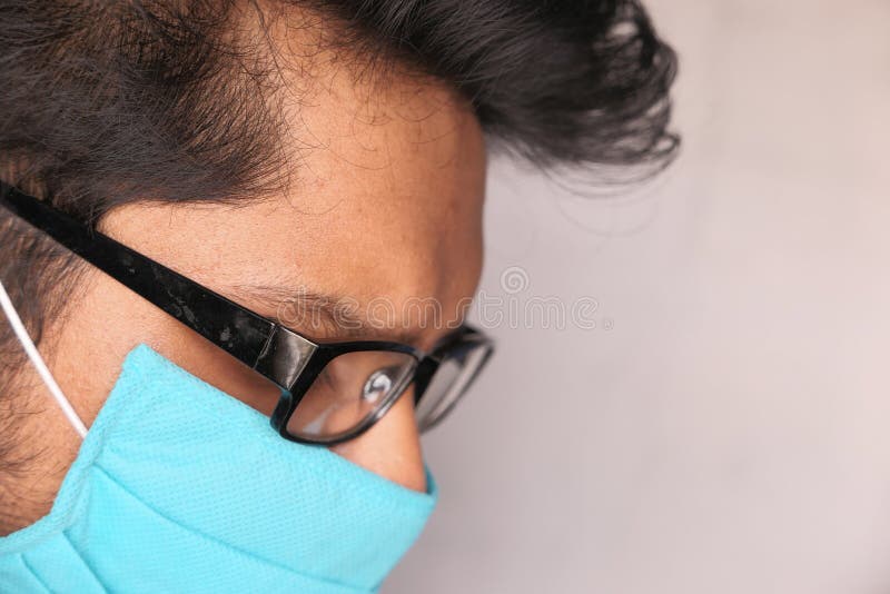 A Sick Man with a Mask on His Face Looking Down Stock Photo - Image of ...