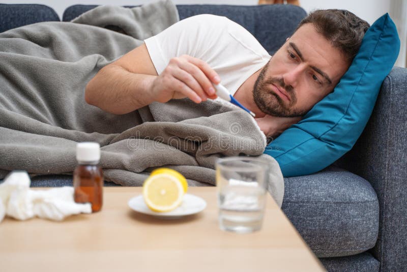 Sick Man Portrait on the Sofa Checking Fever Temperature Stock Photo ...