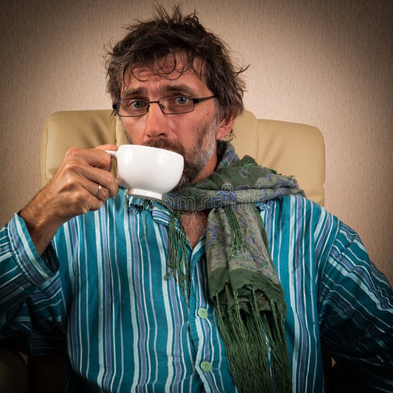 Sick Man Sitting in Chair with Cup Stock Photo - Image of home, pajamas ...