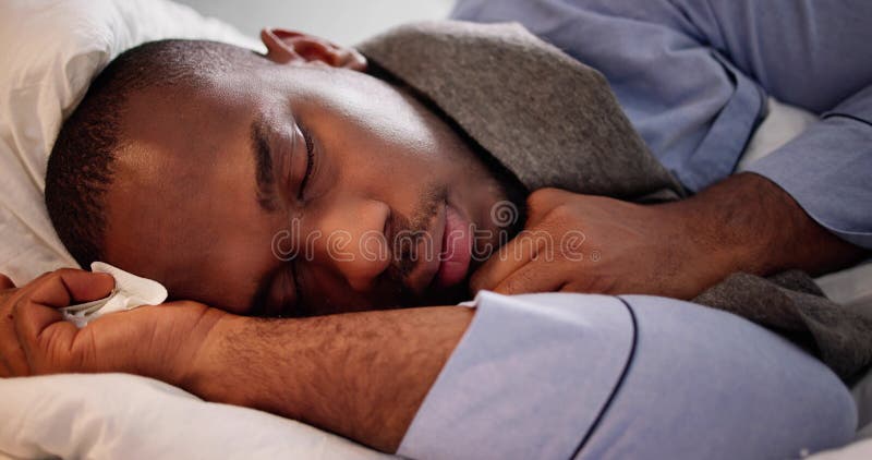 Sick Man Sleeping in Bed stock photo. Image of black - 281332820