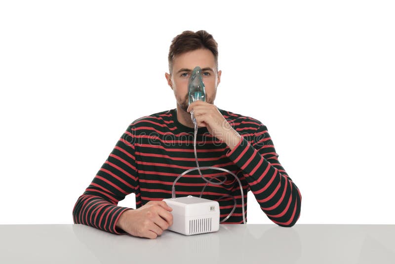 Sick Man Using Nebulizer for Inhalation at Table on White Background ...