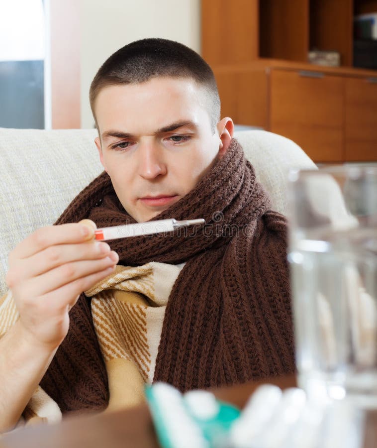 Sick Ordinary Man Looking by Thermometer Stock Photo - Image of ...
