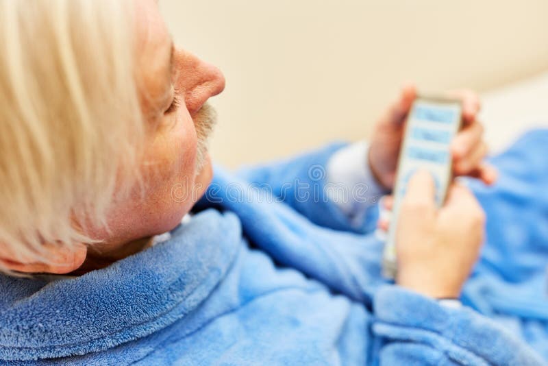 Sick Senior in Nursing Bed with Remote Control Stock Photo - Image of ...