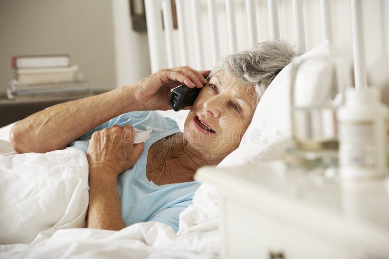 Sick Senior Woman in Bed at Home Talking on Phone Stock Image - Image ...