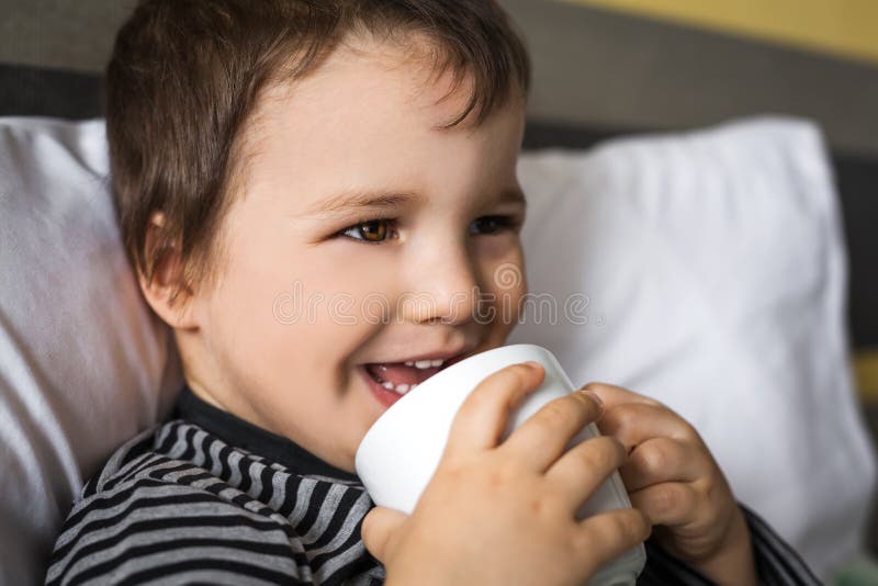 Sick Smiling Child Boy Taking Cup of Medicament Lying on Bed Stock ...
