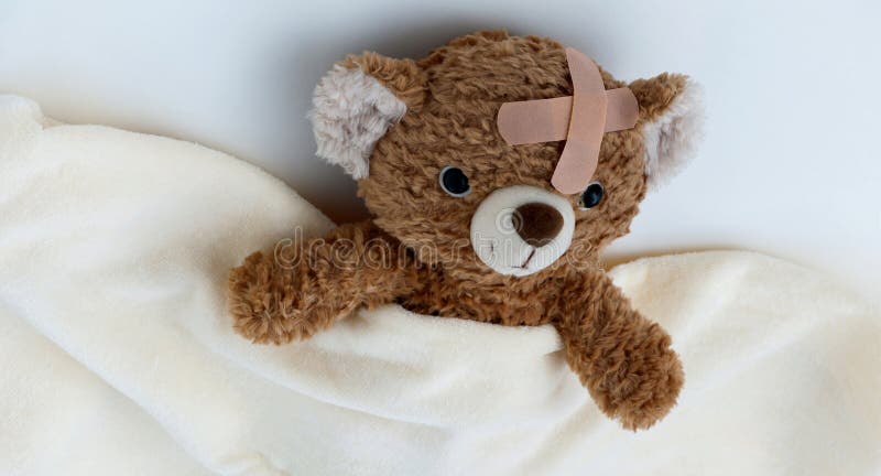 Sick Teddy Bear Toy with Patch on Head Lying in Bed Stock Image - Image ...