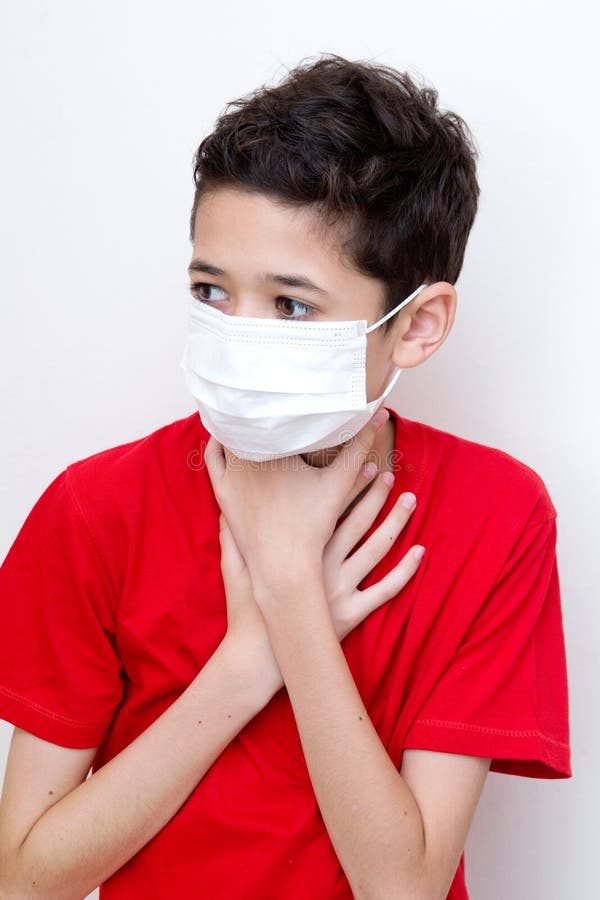 Sick Young Boy Clutches His Throat with Face Mask on. Stock Photo ...