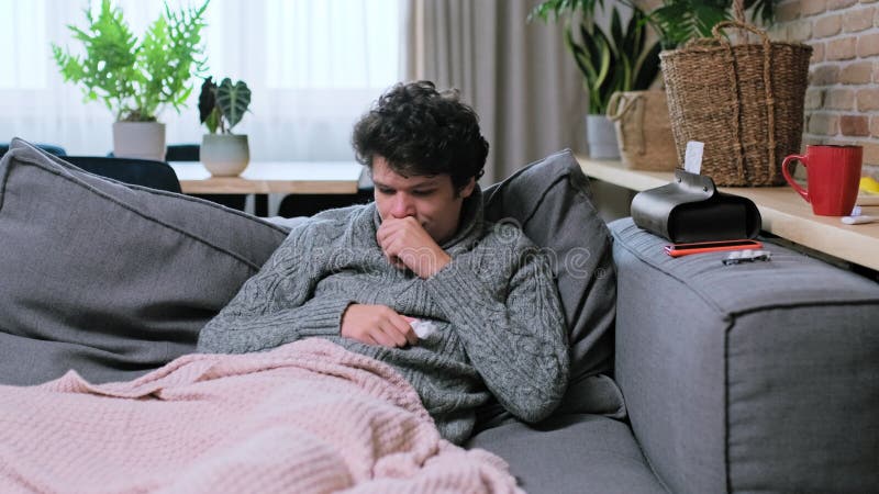Sick Young Guy Coughing Sitting On Couch At Home Stock Footage Video