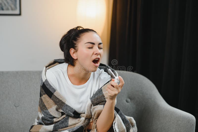 Sick Young Woman in Scarf Using Cough Spray. Stock Image - Image of ...