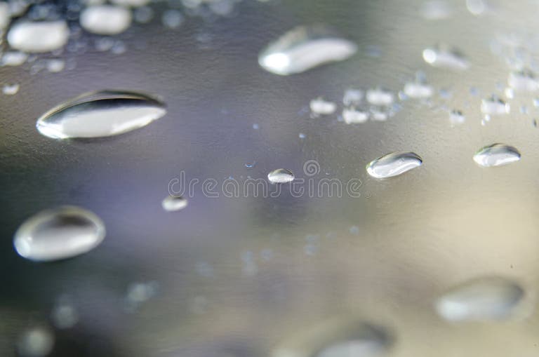 Side Angle of Clear Raindrops on a Transparent Surface. Rain Reflections Theme. Stock Image ...