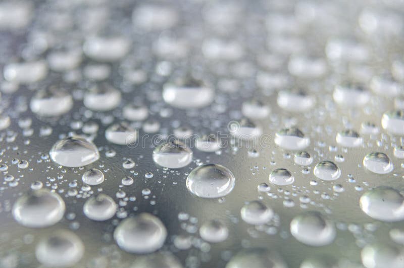 Side Angle of Clear Raindrops on a Transparent Surface. Rain ...