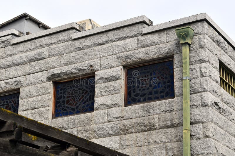 Side of a Building with Facade Siding and Patterned Windows Stock Photo ...