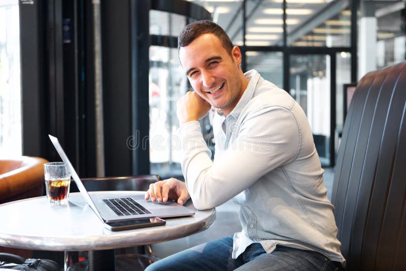 Side of Happy Man Sitting at Cafe with Laptop Computer Stock Image ...