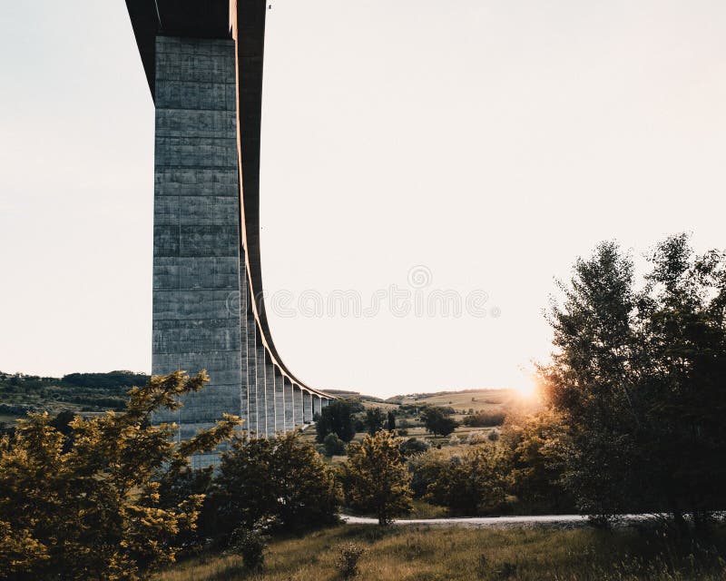 Side of a High Stone Highway Bridge with Clear White Sky in the ...