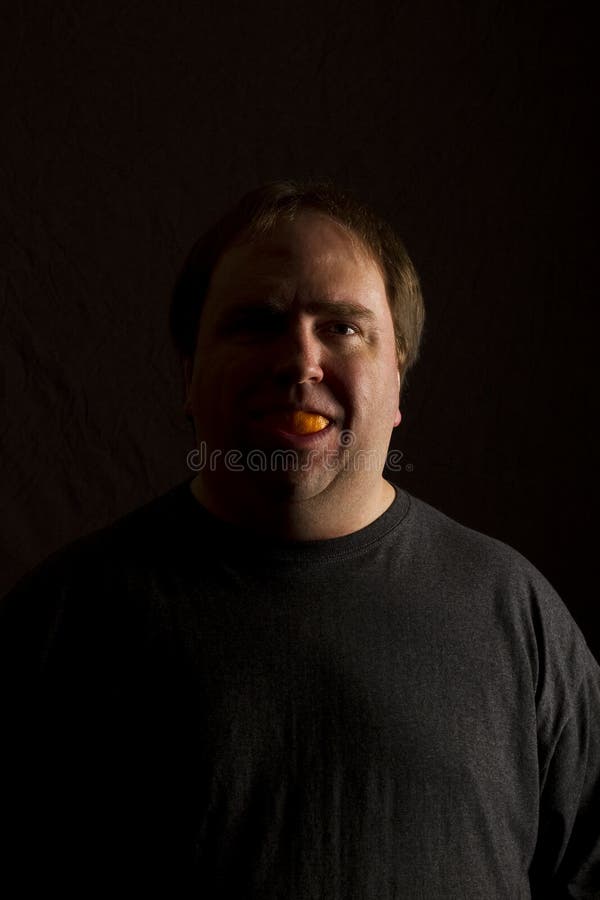 Side-lit Man Orange stock photo. Image of face, white - 19463482