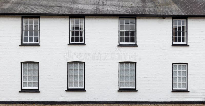 Side of an Old House with White Brick Wall with White Wooden Windows ...