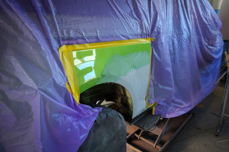 A Side Panel of a Car is Painted Green in a Paint Shop Stock Photo ...