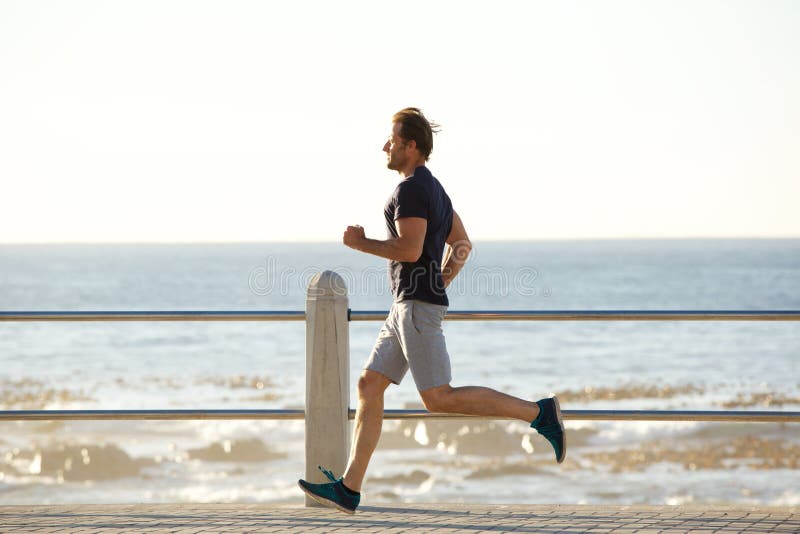 Side Portrait of Active Man Running by Sea Stock Image - Image of ...