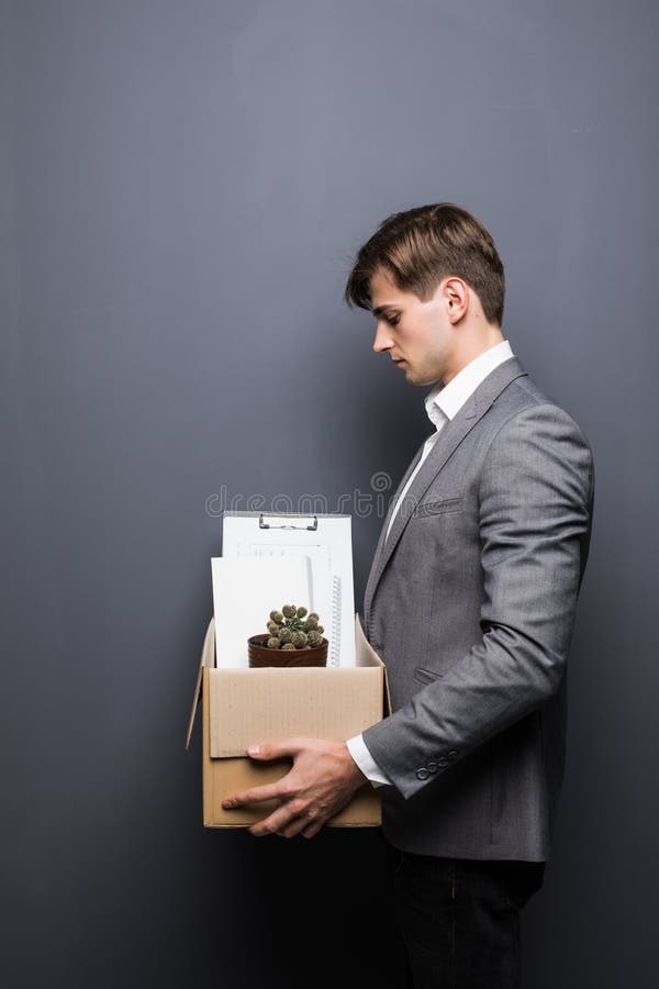 Side Portrait of a Young Businessman Carrying Box at His Workplace ...